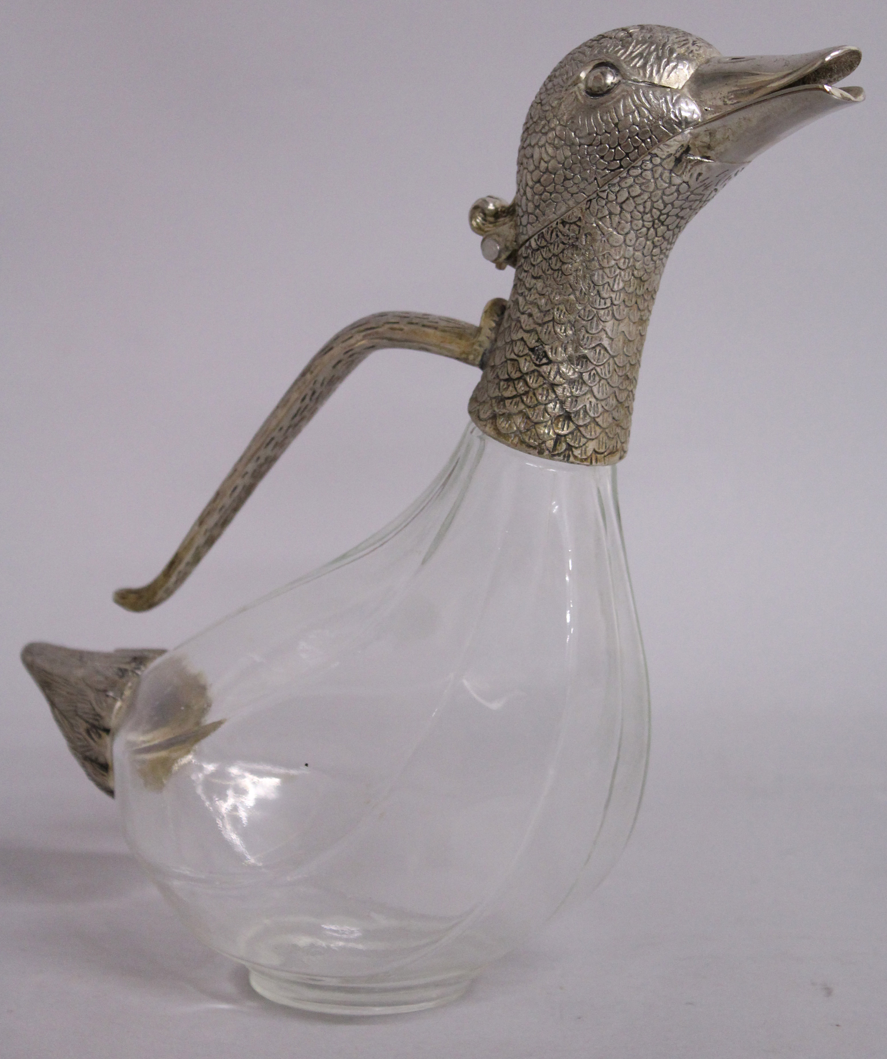 A DUCK CLARET JUG with plated head and tail.