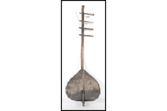 A 20th Century Kenyan tribal Orutu strung musical instrument having a ...