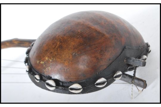 A 20th Century Kenyan tribal Orutu strung musical instrument having a ...