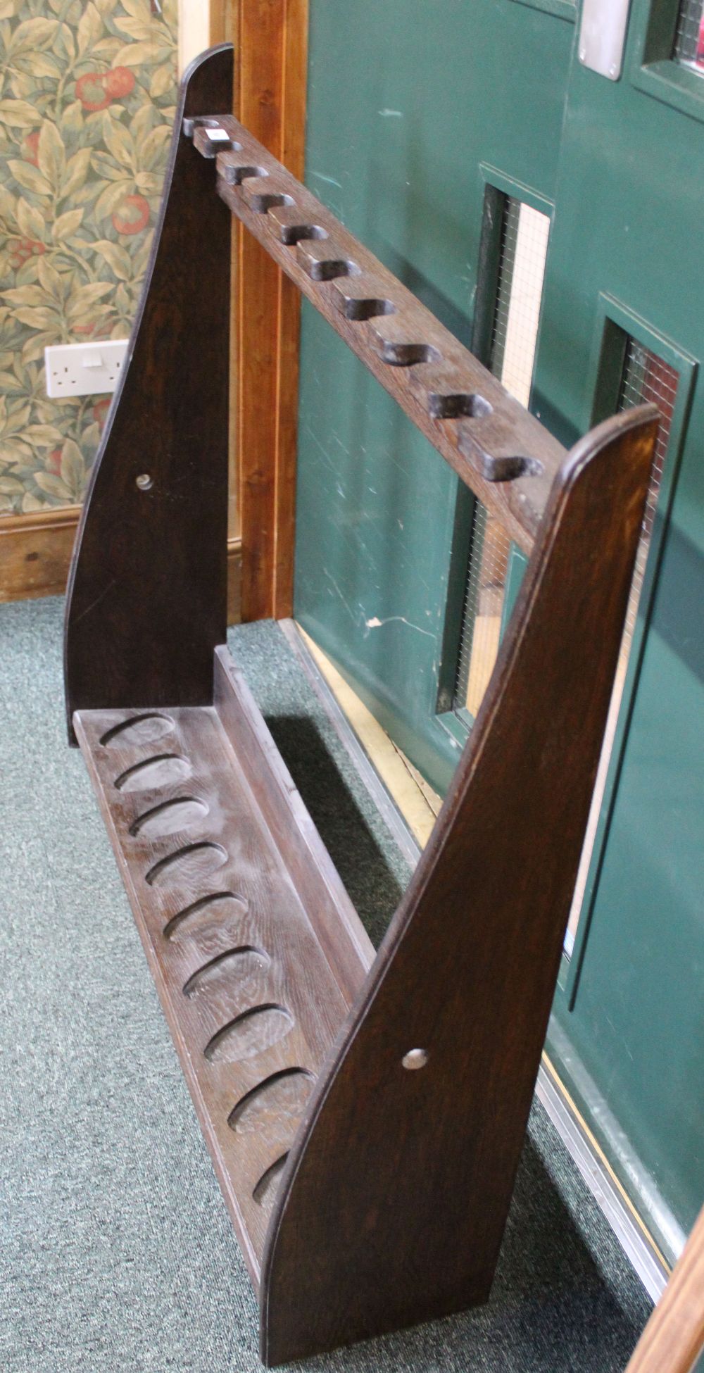 An oak bespoke floor standing gun rack, to hold ten long arms
