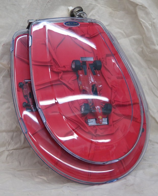 A Ferrari themed toilet seat as manufactured by Elista & Heinzl, and ...