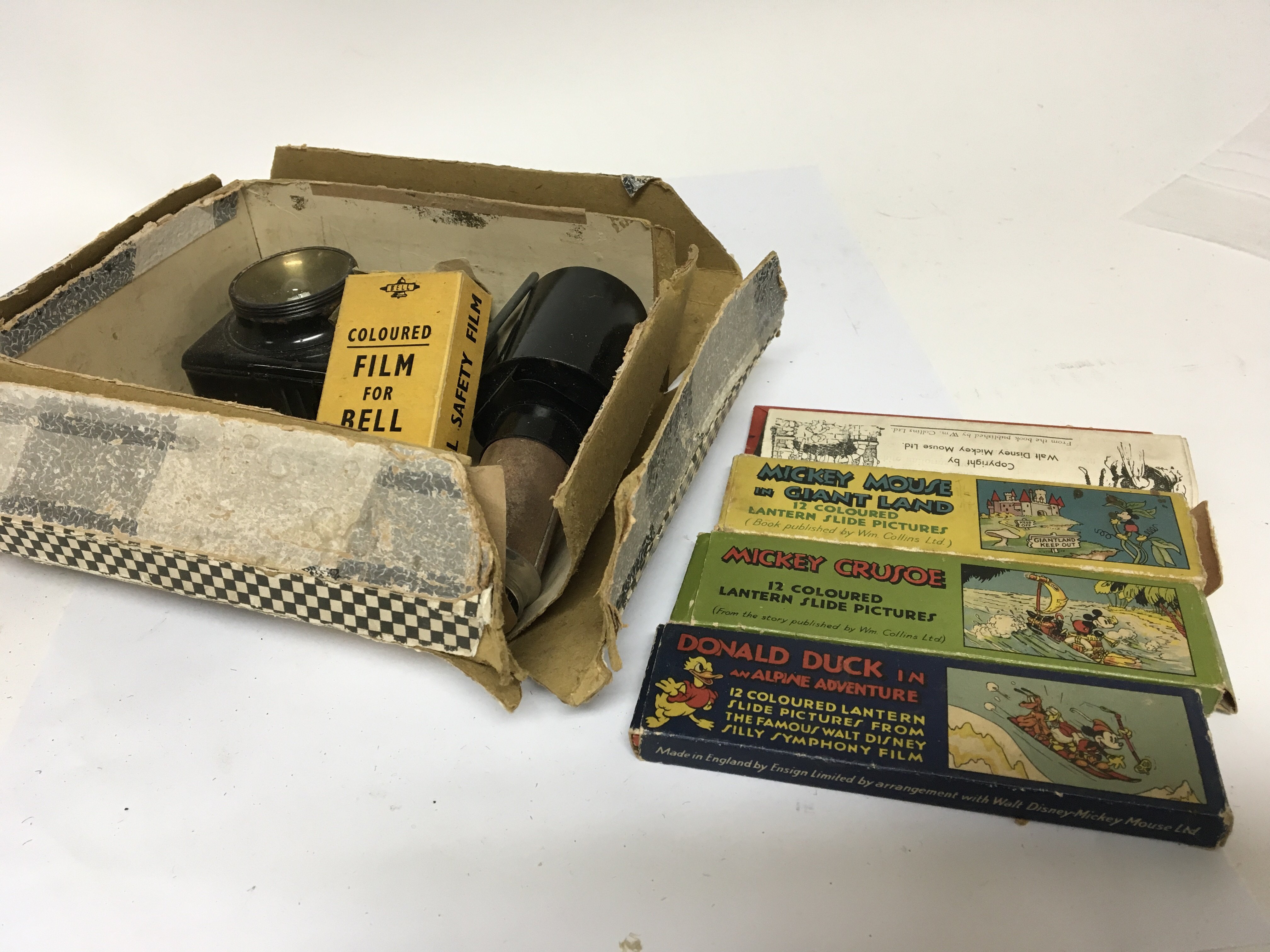 A vintage toy projector with glass Disney Mickey Mouse and Donald Duck ...