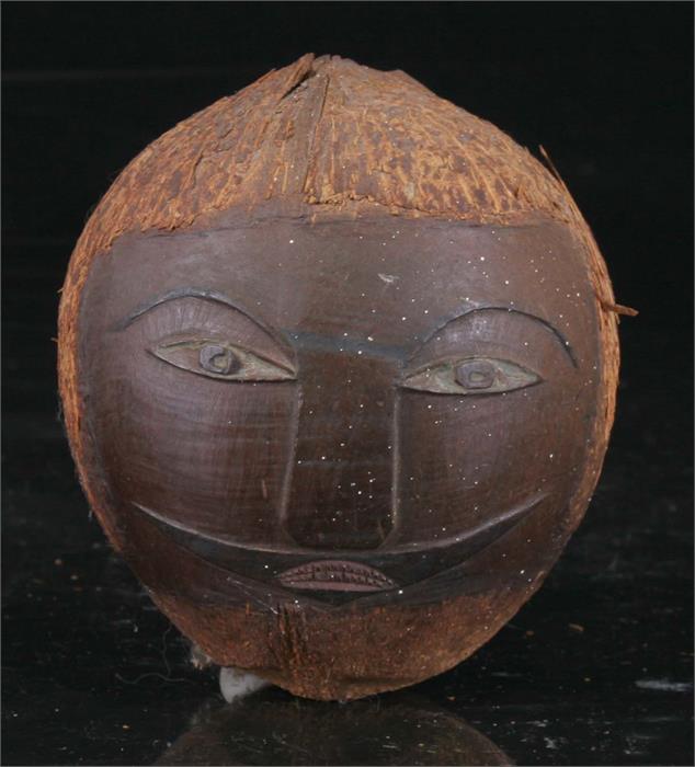 A coconut carving in the form of a head, possibly South Pacific, 12cm high.