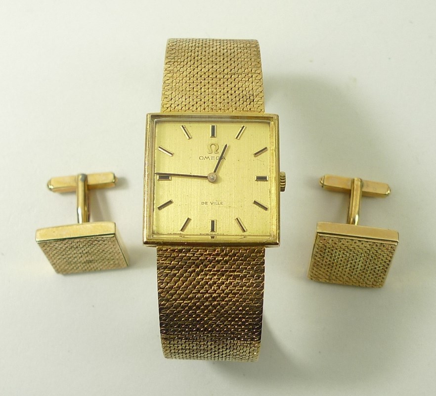 A vintage 9ct gold Omega watch, the square dial with baton numerals ...
