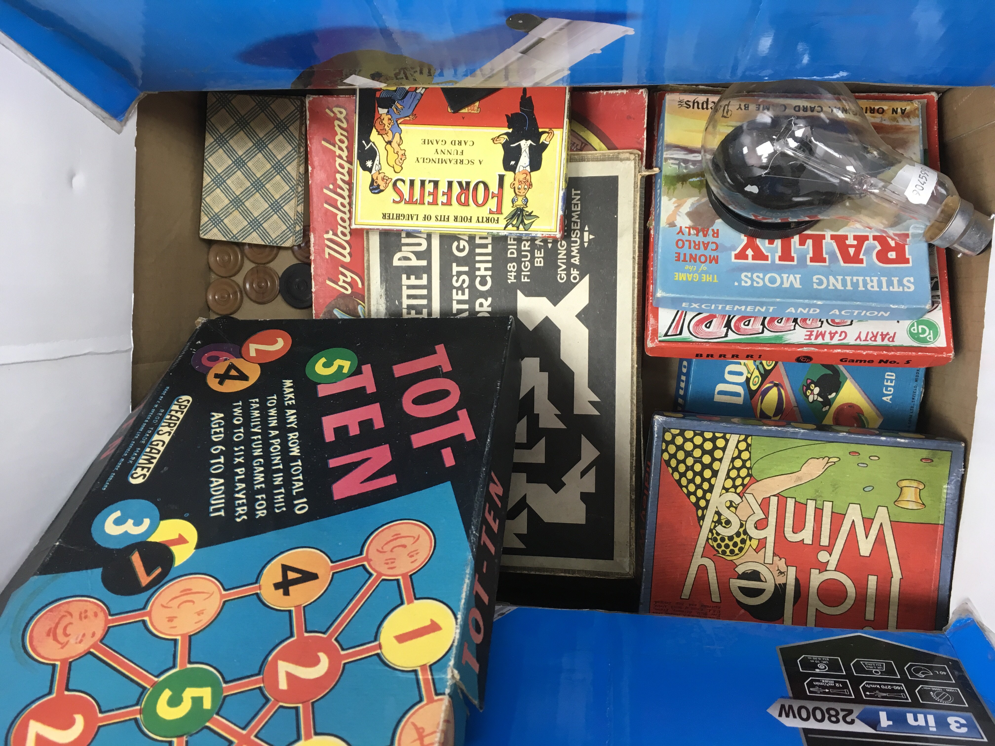 A box of vintage card games, board games and other toys.