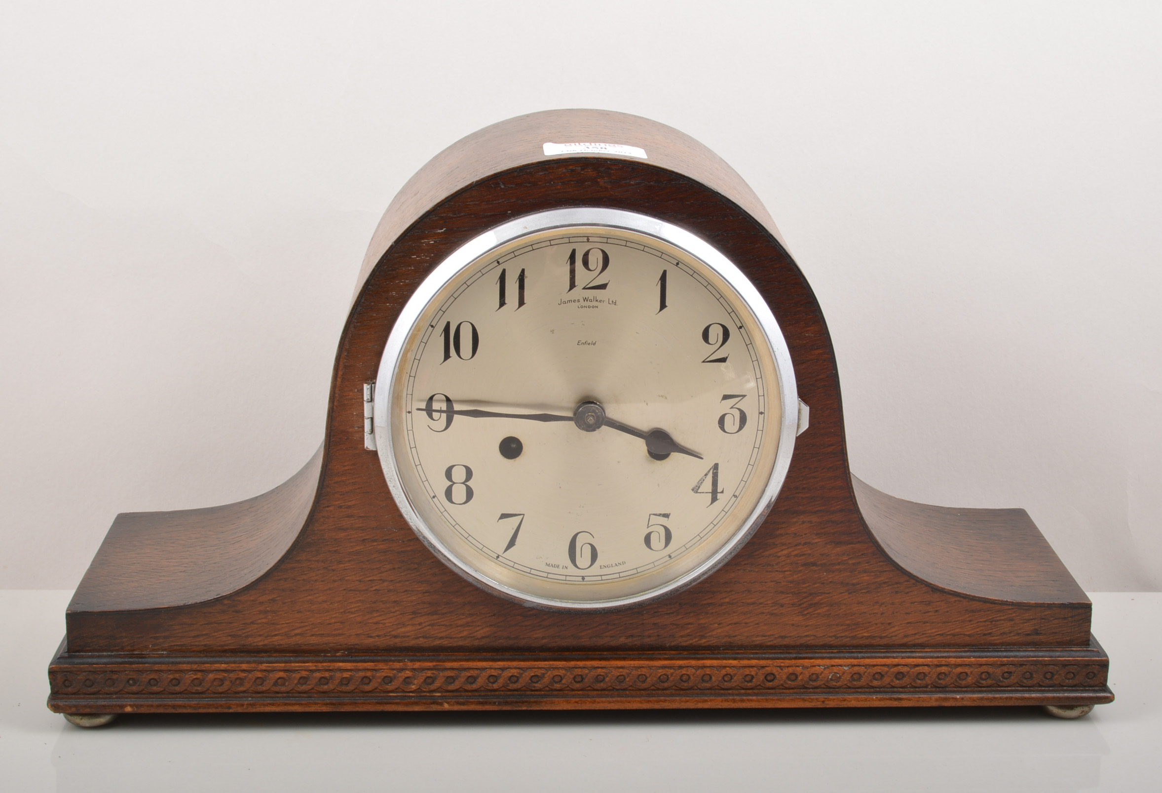 Oak cased Napoleon's hat mantel clock, silvered dial signed James ...