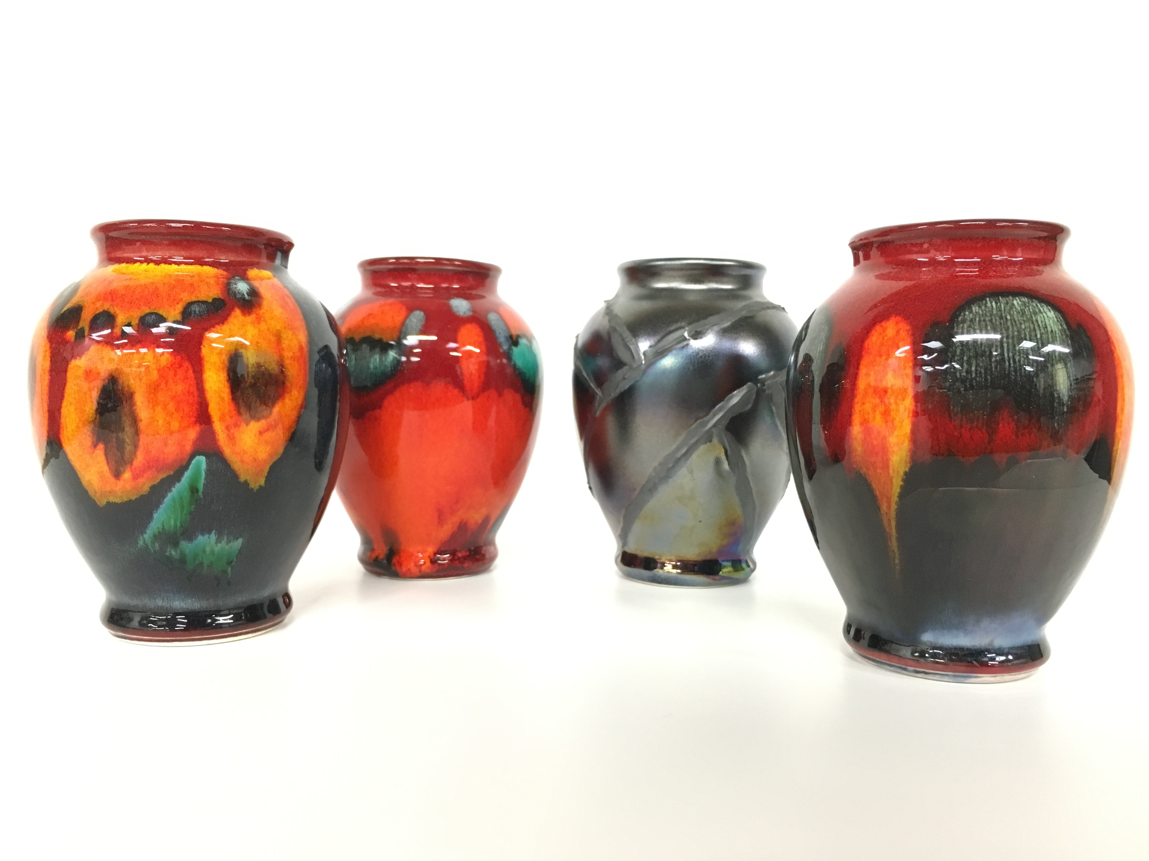 Four Poole Pottery Living Glaze miniature vases, decorated in the Wild ...