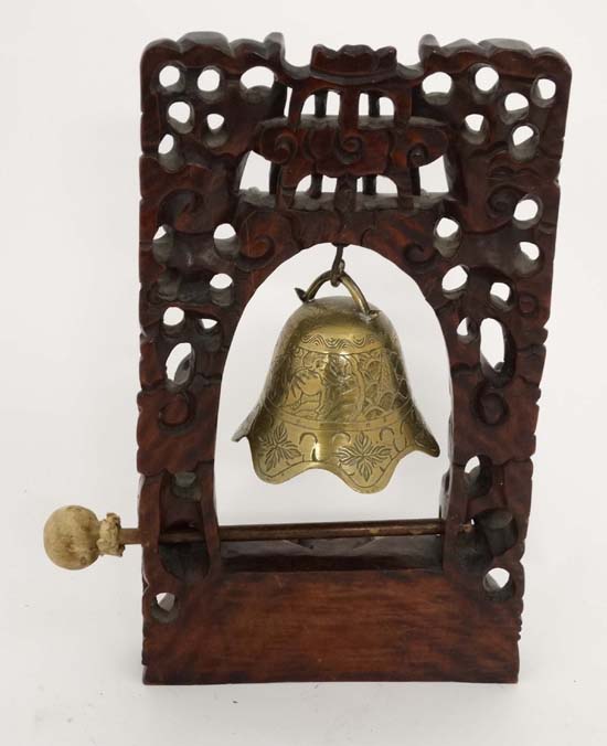 An Chinese temple bell with carved hardwood surround and ornate brass ...
