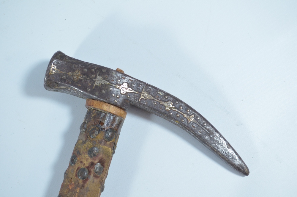 An engraved war pick with stud decorated shaft, length 82cm, and a ...
