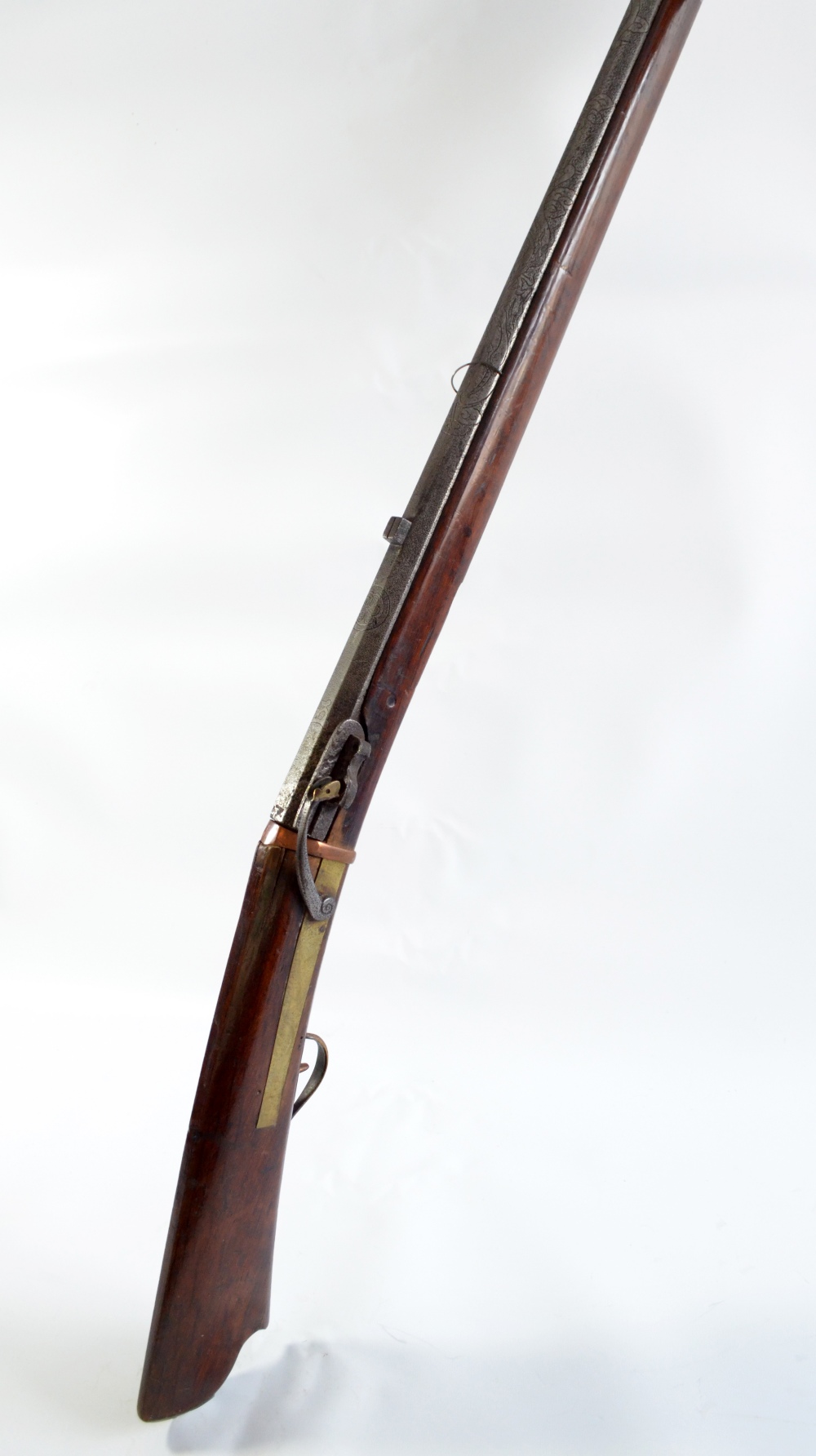 A Chinese matchlock rifle fitted with engraved octagonal barrel ...
