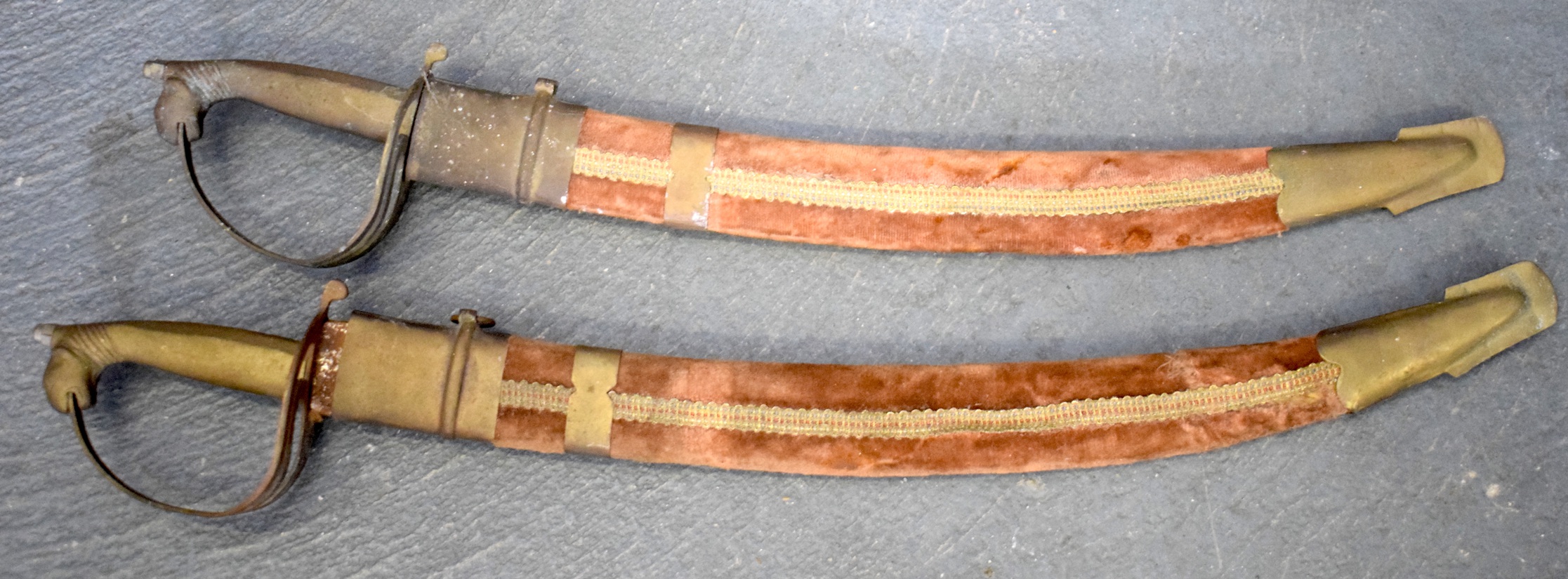 A PAIR OF MID 20TH CENTURY EASTERN SWORDS, formed with curved blades ...