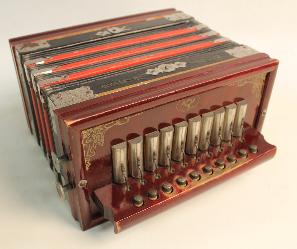 A 'REGAL MELODEON' SQUEEZE BOX, with white keys and dark red painted ...