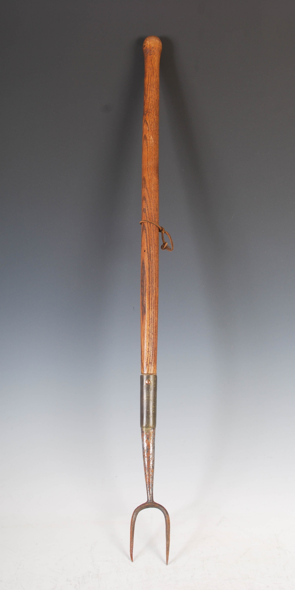An antique pitch fork, with steel prongs and turned ash handle, 93cm long.