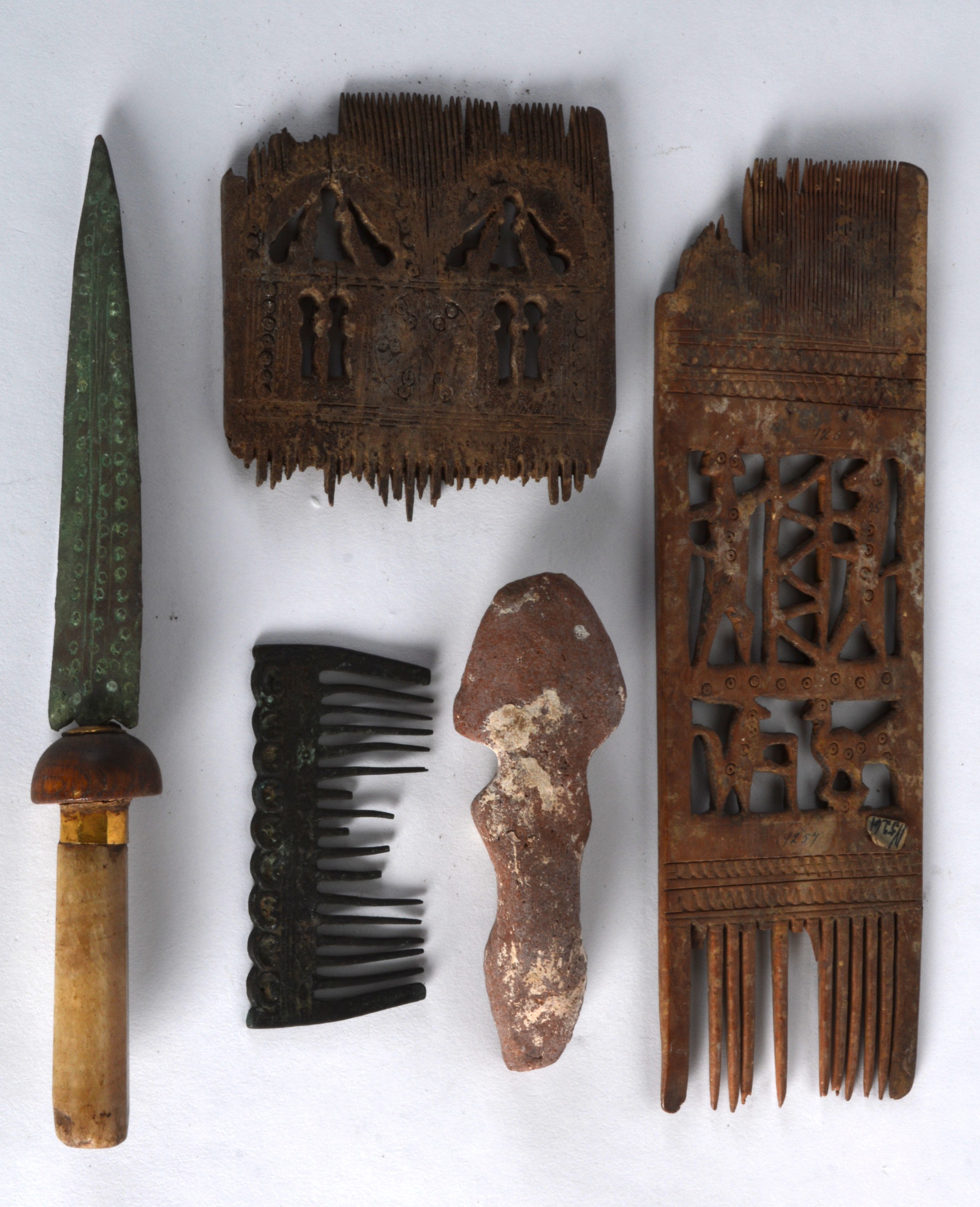 A Collection of early Egyptian combs, together with a painted fertility ...