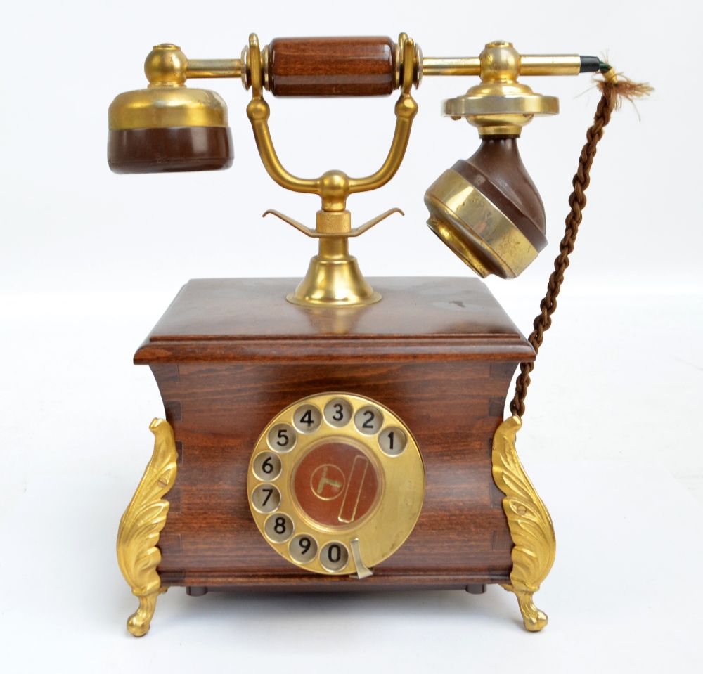 A reproduction wooden and gilt metal detailed telephone with spin dial ...