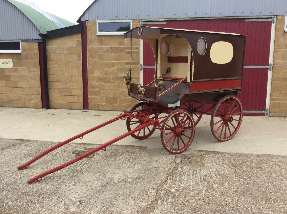 A horse drawn four wheel baker's cart with a set of brass lamps and whip