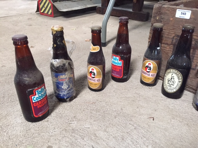 A Tolly Cobbold wooden ale crate and contents of 22 old sealed beer bottles