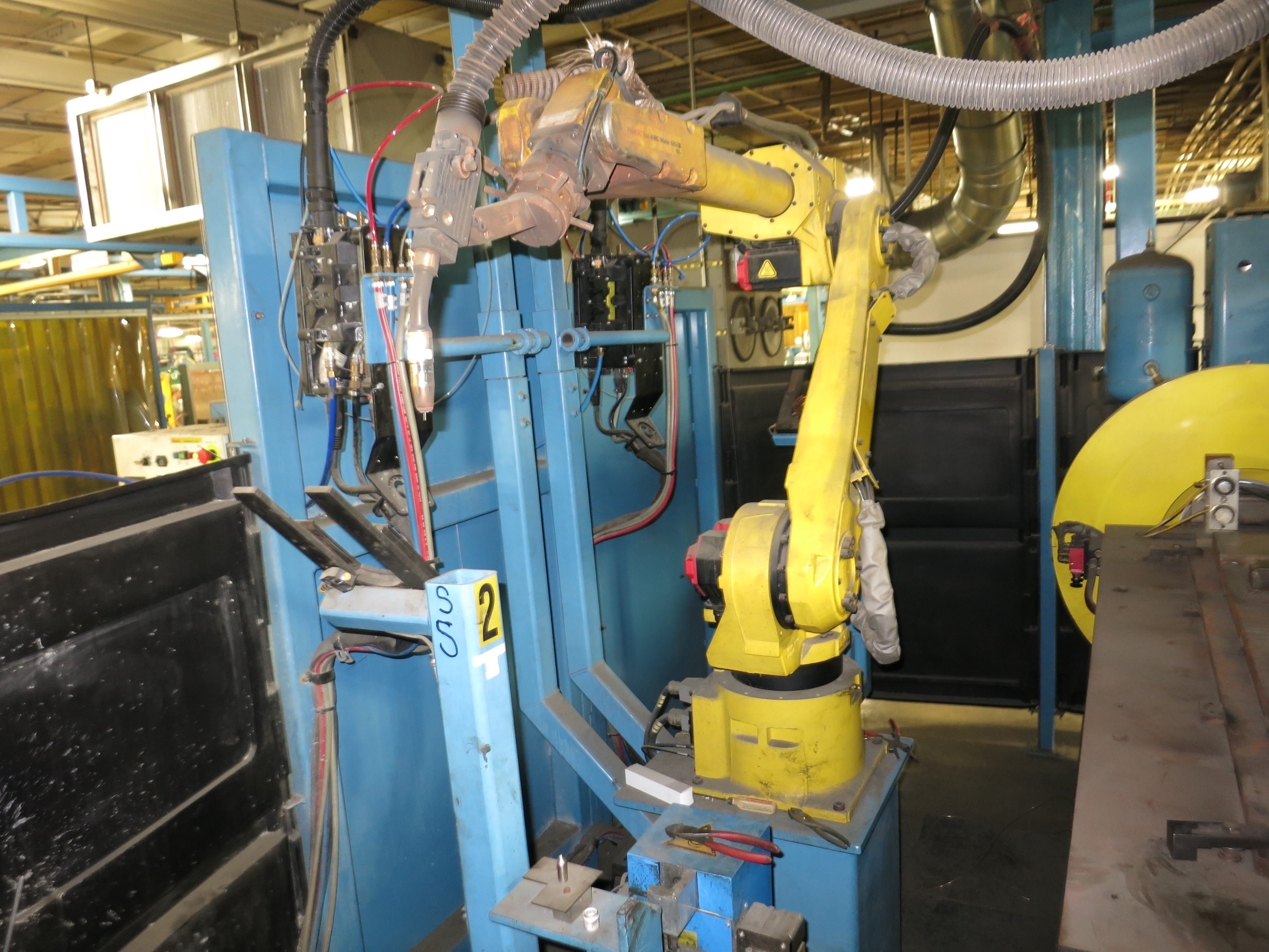 Genesis robotic trunnion welding cell featuring Fanuc robotics; robot ...