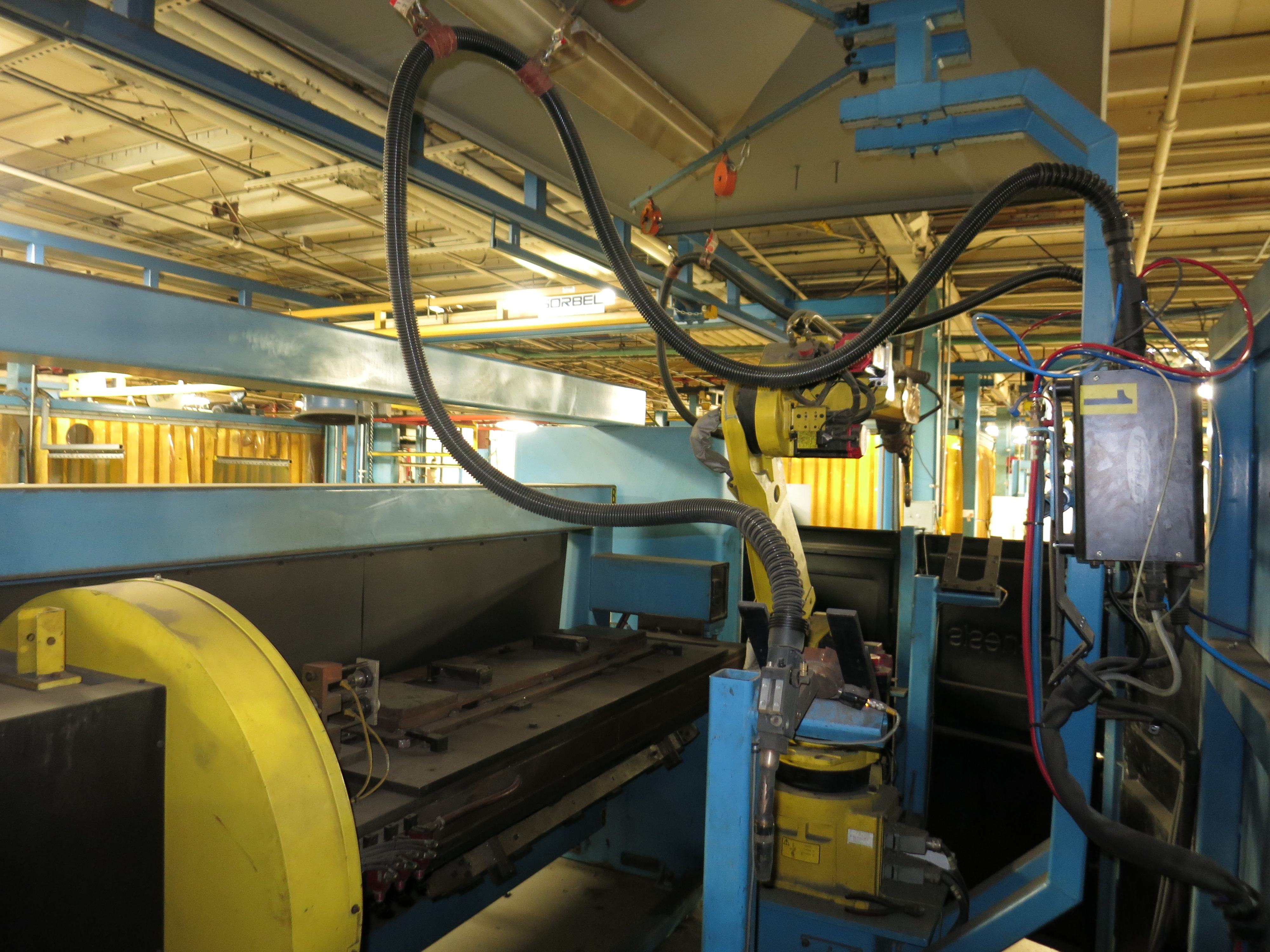 Genesis robotic trunnion welding cell featuring Fanuc robotics; robot ...