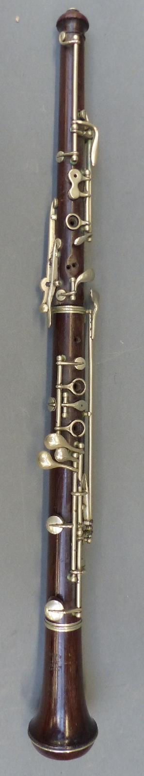 An early French rosewood oboe marked 'Breveté, Triebert a Paris'
