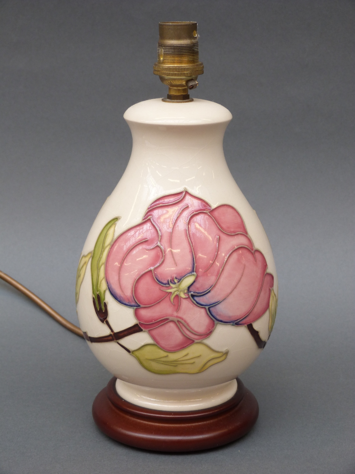 A Moorcroft table lamp in the Hibiscus pattern on cream ground, 27cm tall