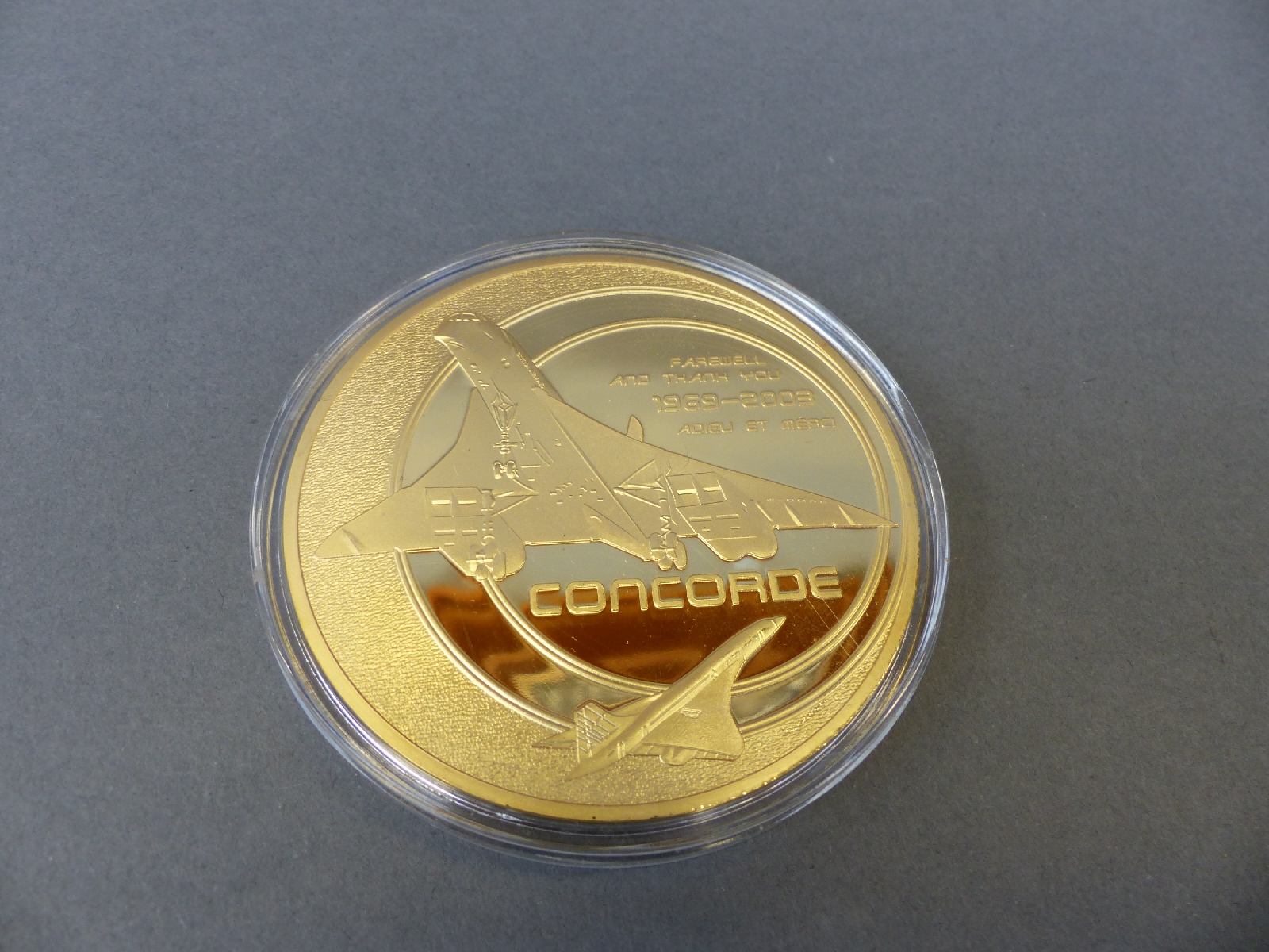 A miniature gold proof commemorative coin for Concorde's final farewell ...