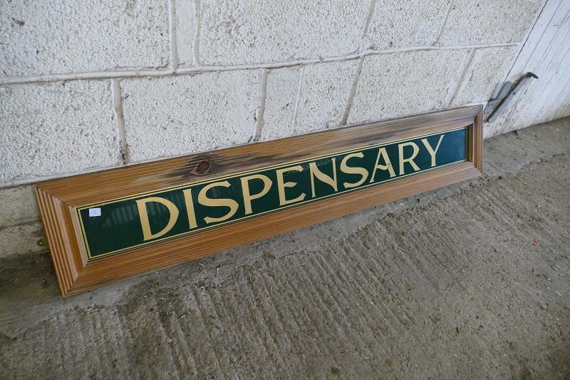 A modern dispensary sign, 30cm high by 150cm wide.