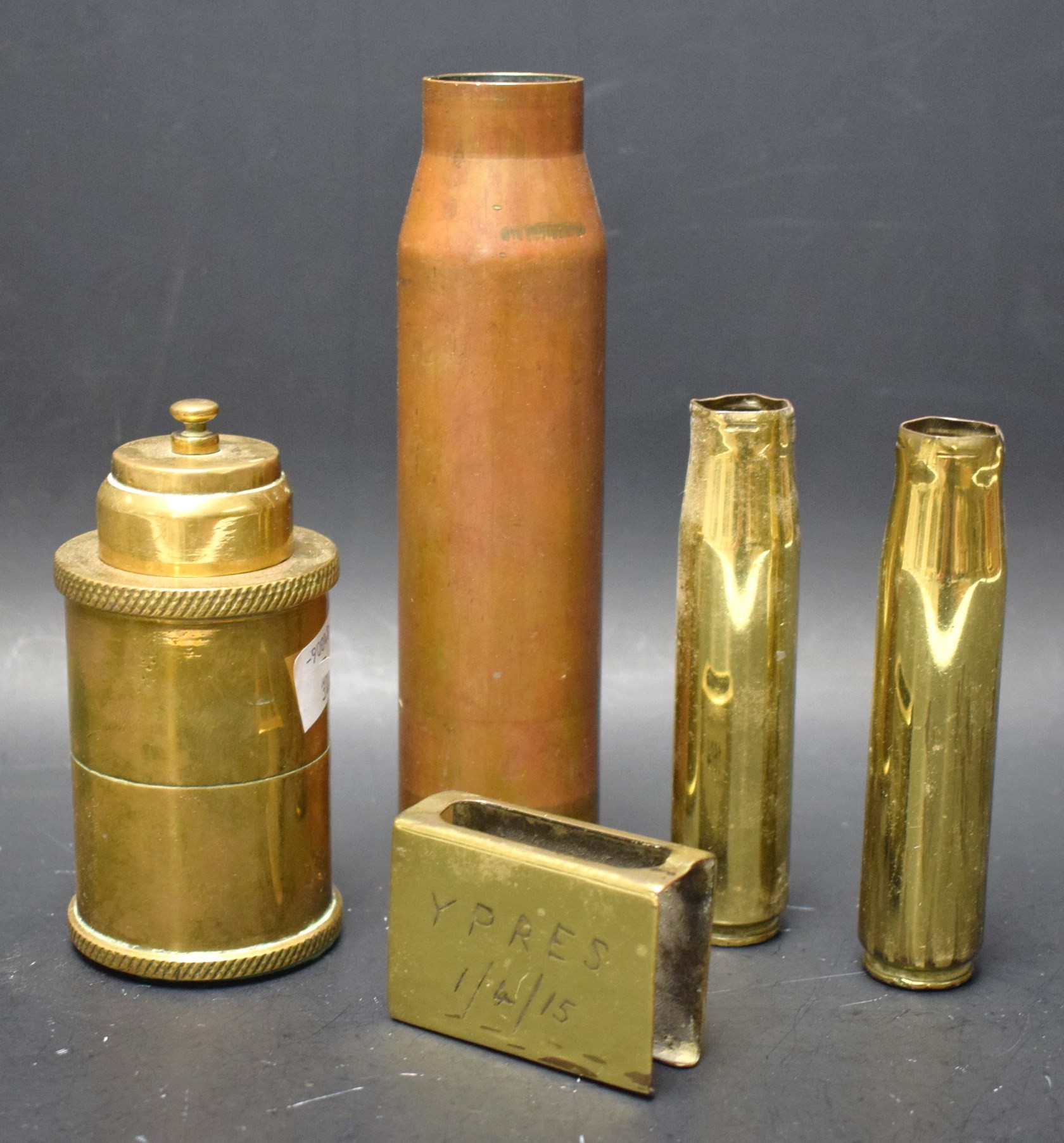 A Trench Art shell lighter; Ypres 1/4/15 matchbox case; 30mm shell case; two 20mm MK2 shell cases