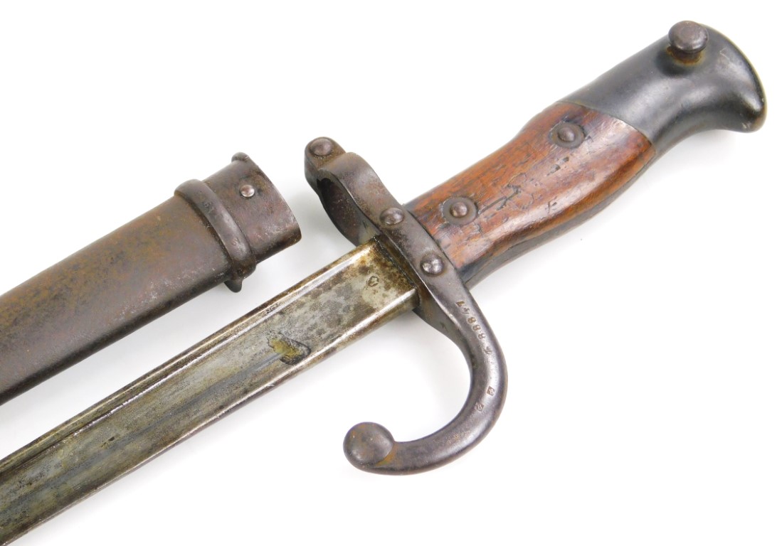 An 1880 model French bayonet, with shaped blade, tapering scabbard ...