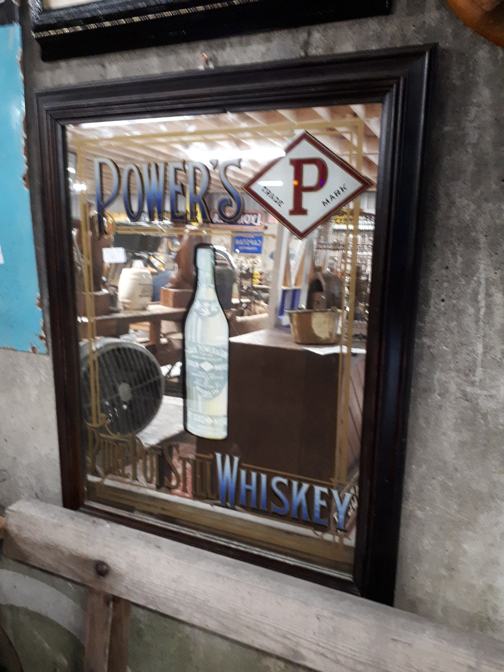 Framed Powers whiskey mirror.