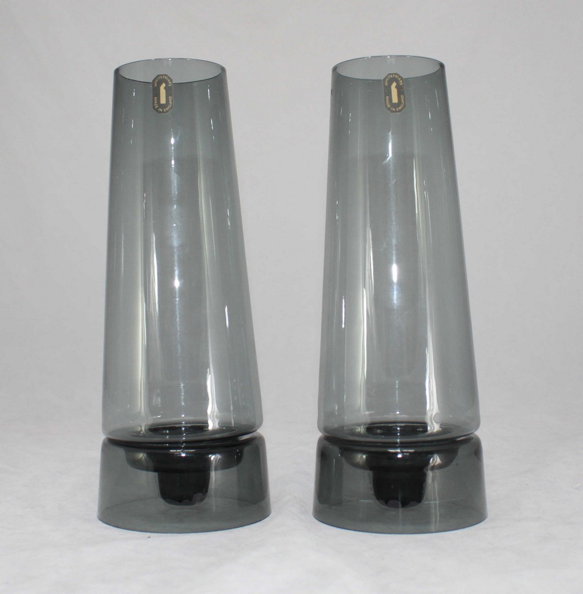 A pair of Whitefriars blue glass candle holders with shades. 24cm high.