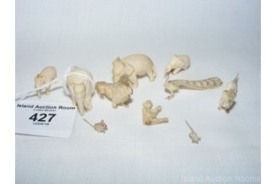 Collection of small carved ivory animals, including elephants, mice ...