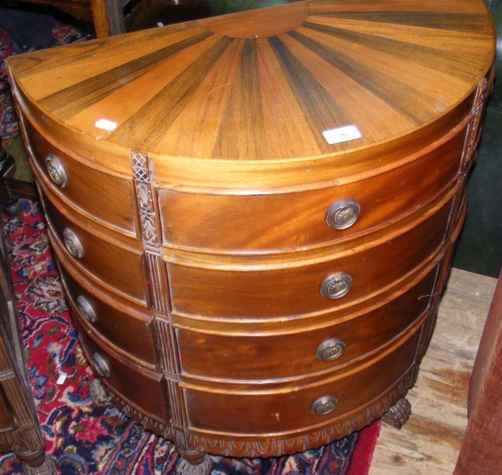 A half round antique style multi chest of drawers, standing on carved ...