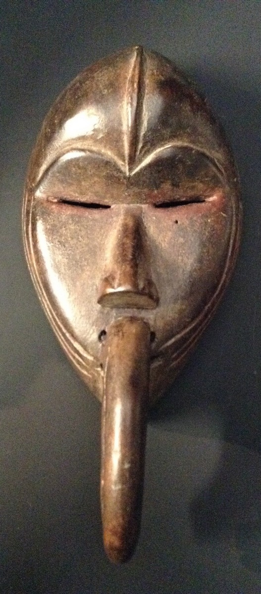 Tribal Art - an African mask, domed forehead with central ridge, narrow ...