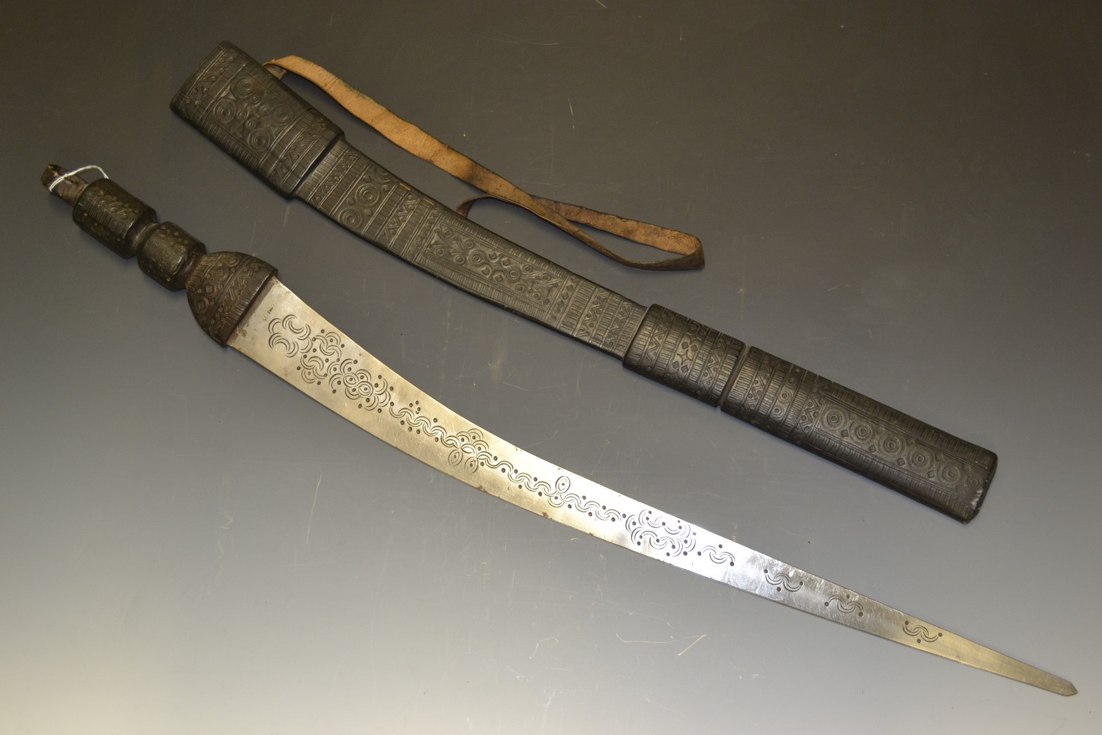 A Sudanese sword, 71cm blade engraved with foliate curves, tooled ...