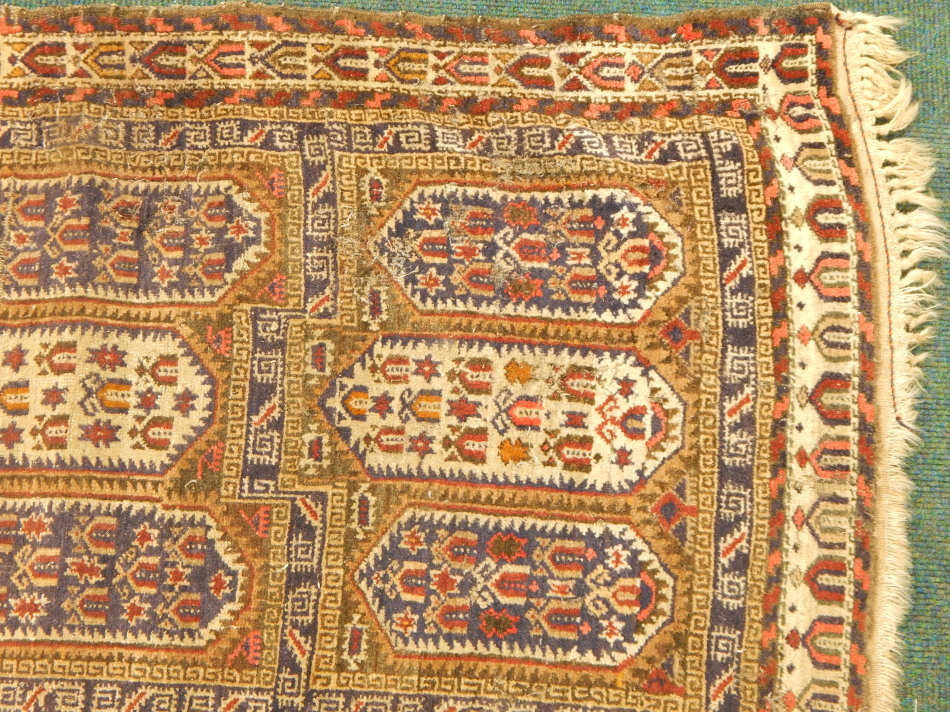 An early 20thC Middle Eastern rug, with a repeat geometric pattern ...
