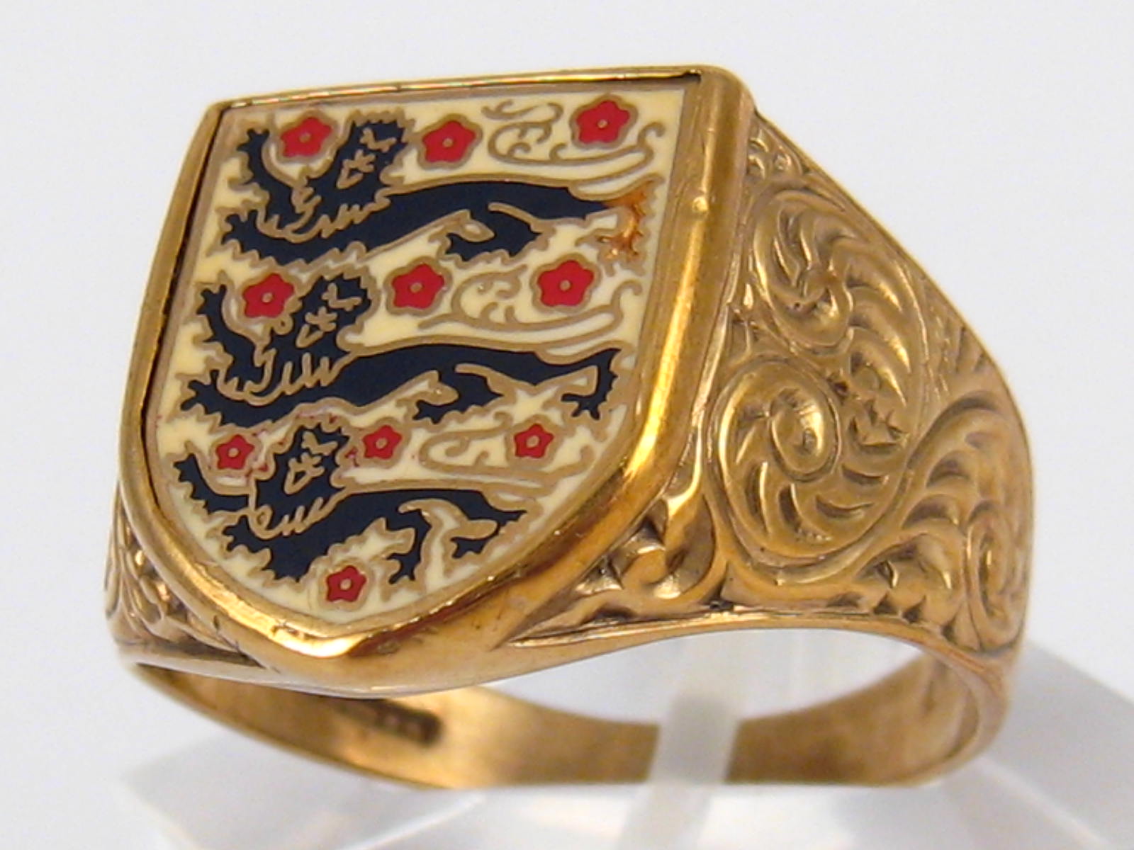 A 9 carat gold ring, enamelled with the Royal Arms Of England ( three ...