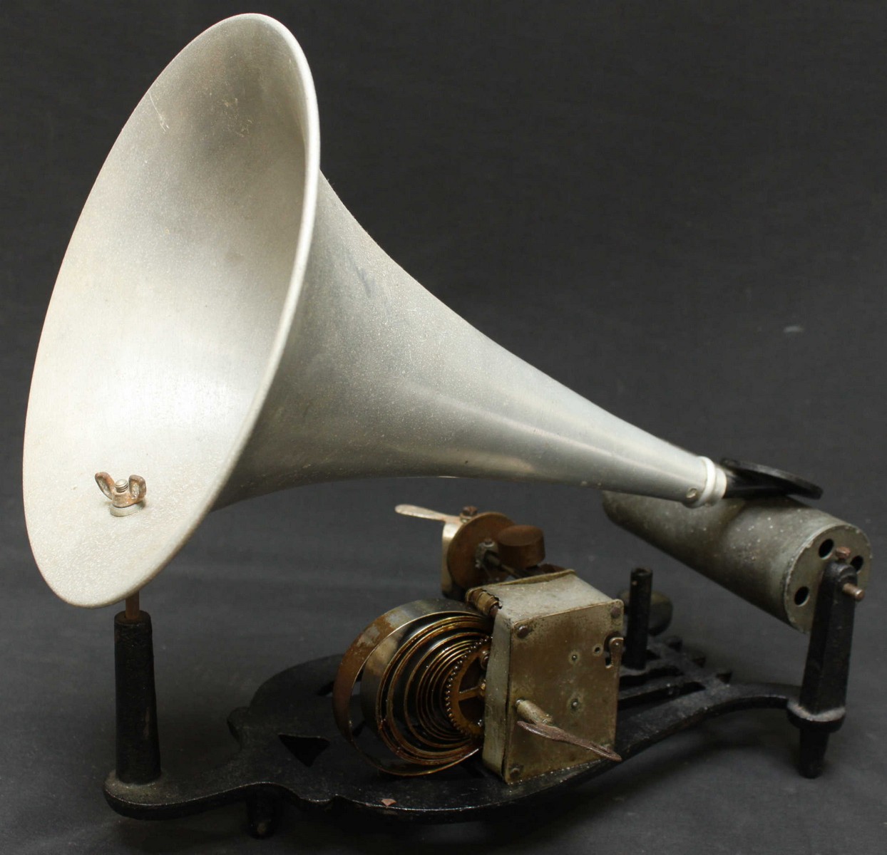 An early clockwork Puck phonograph, with lyre-shaped base and aluminium ...