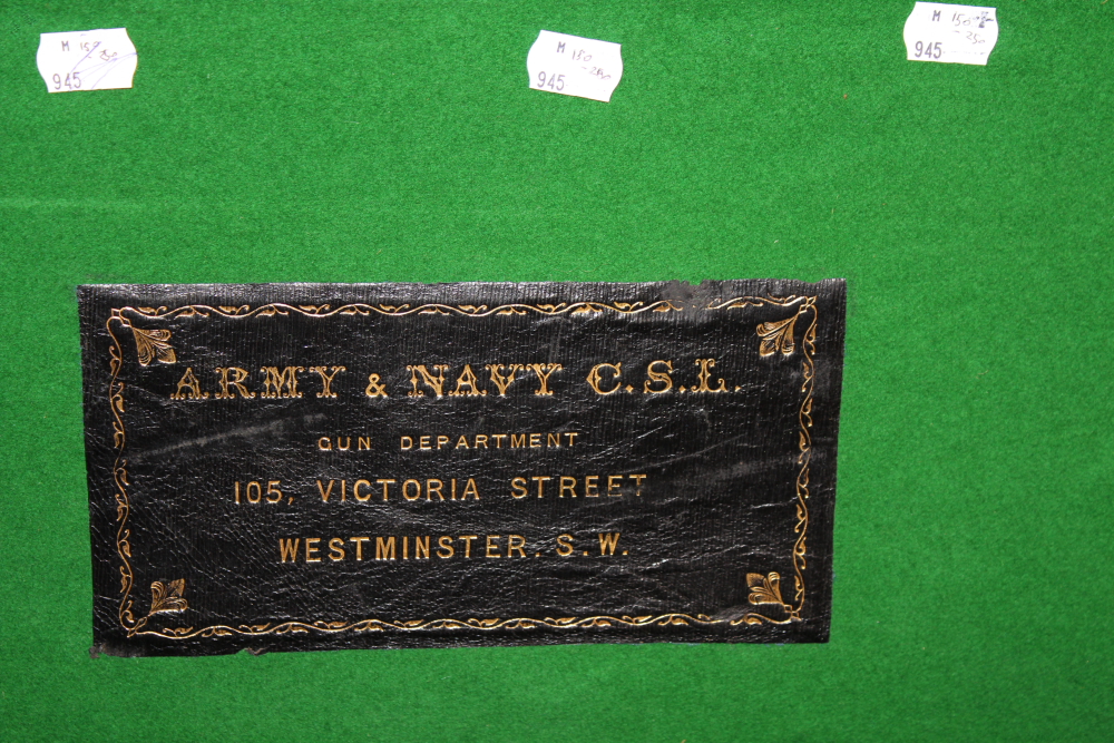 A vintage leather double shot gun case with Army and Navy trade label.