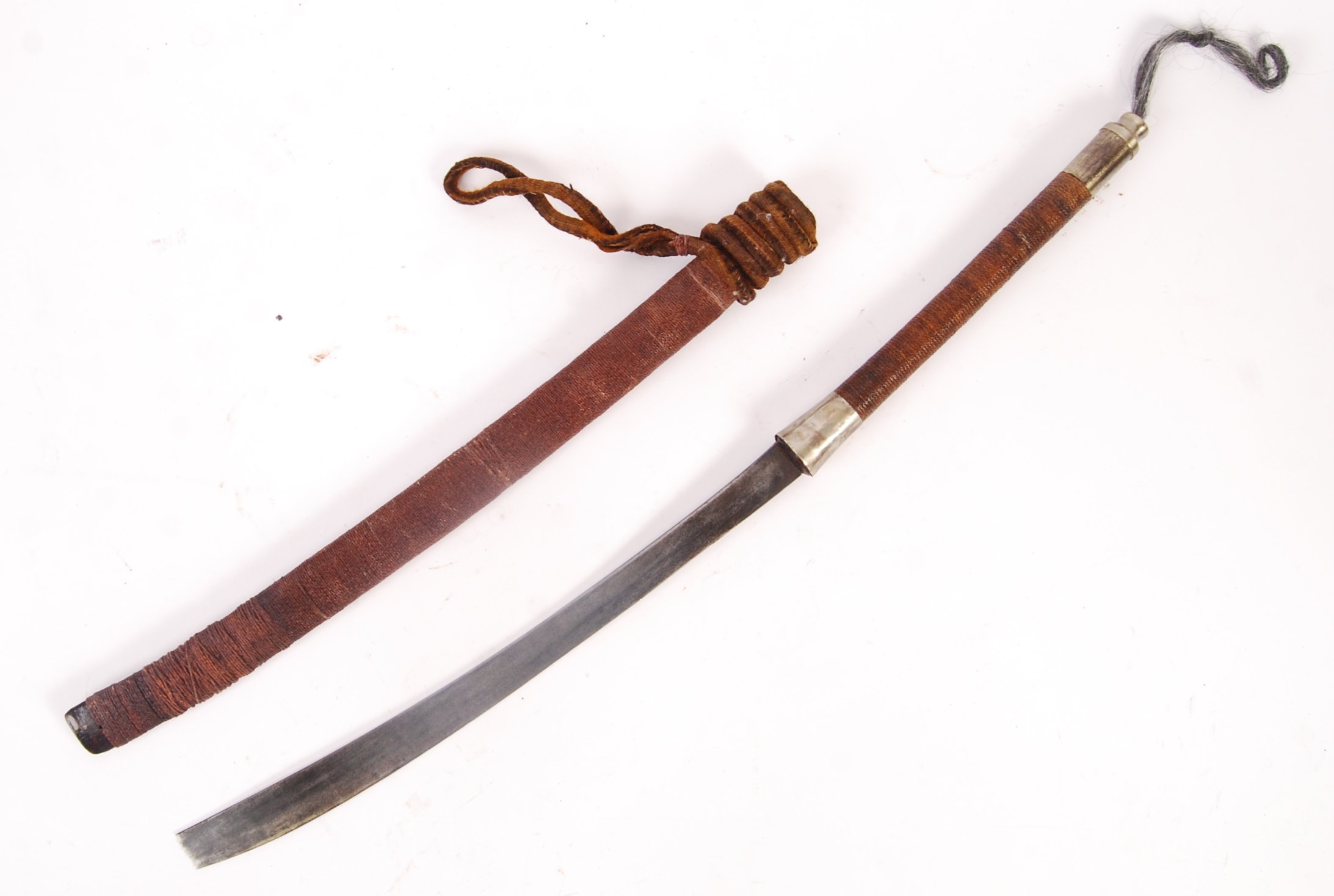 A Vietnam era 20th century Myanmar Burmese Dha Sword having a straw ...