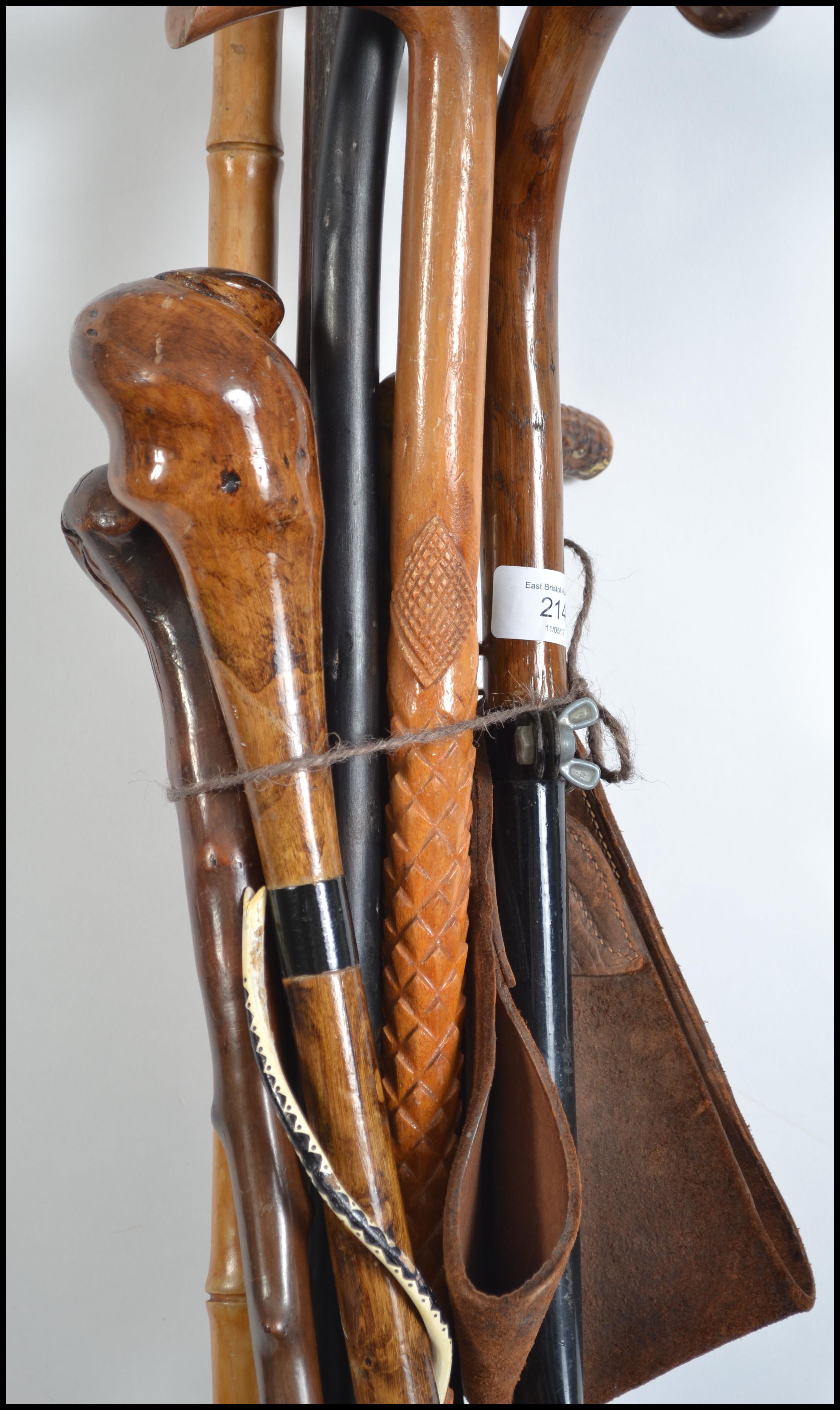 A collection of African and Polynesian hard wood carved walking sticks ...