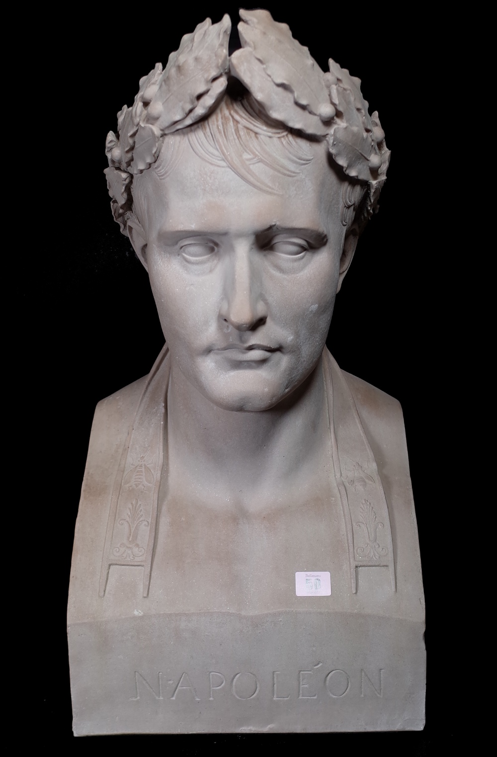 A modern composite marble bust of Napoleon wearing a laurel wreath ...