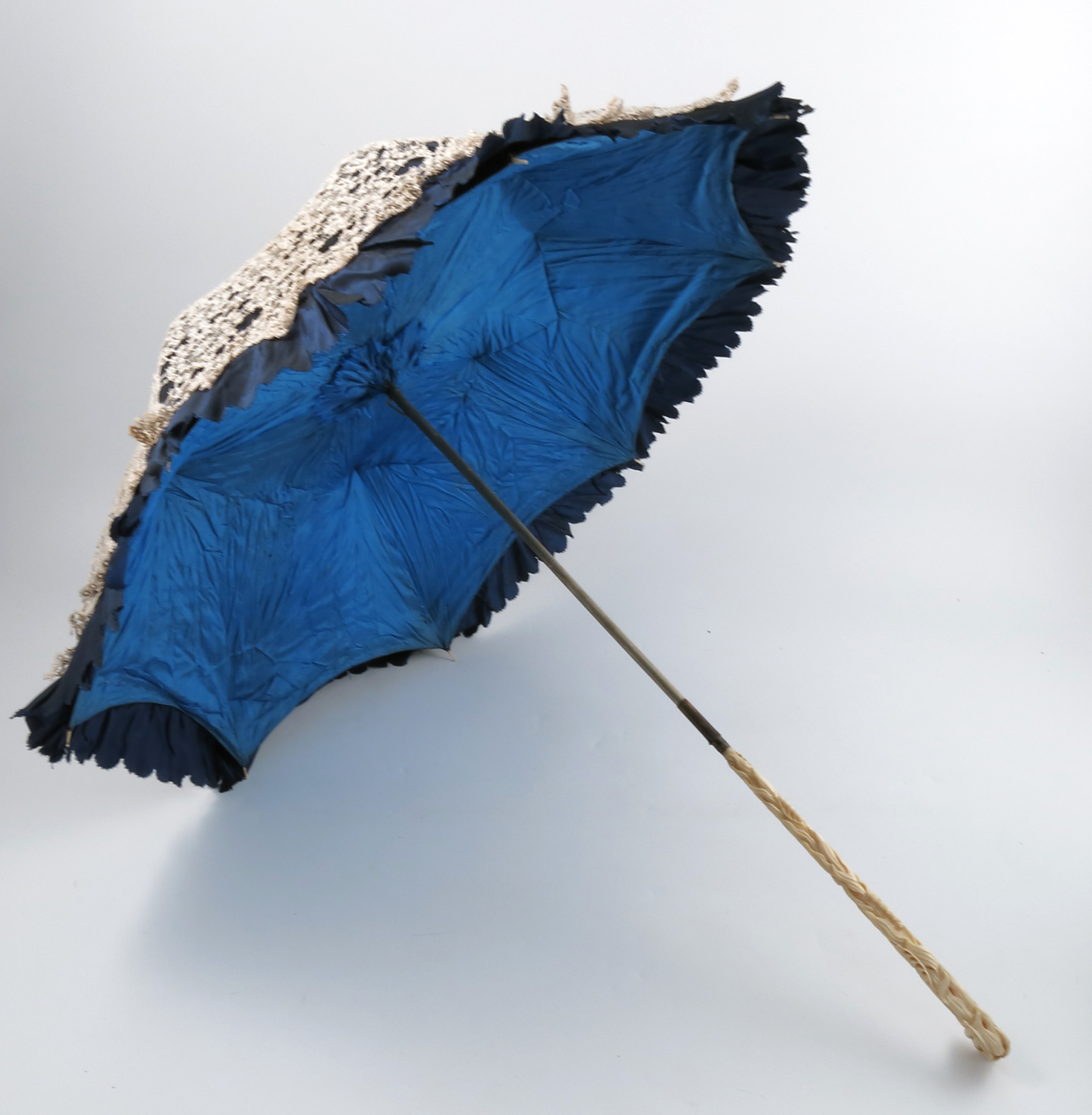 A 19th century lady's parasol, the carved ivory folding handle ...