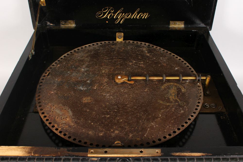 A CASED POLYPHON playing 15-inch discs, the rising top opening to ...