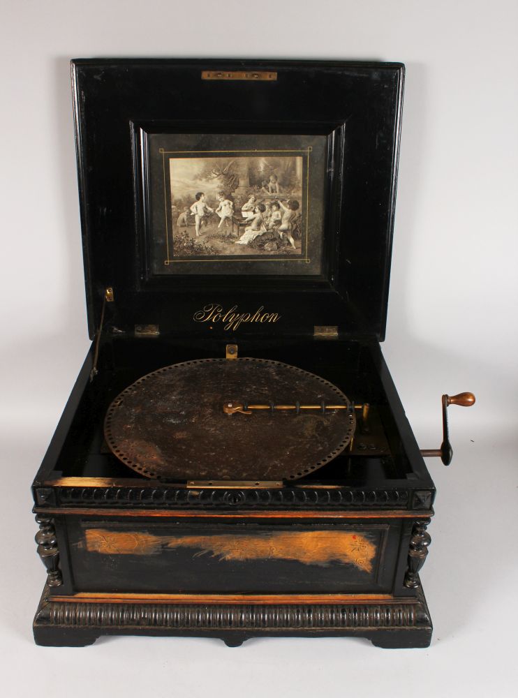 A CASED POLYPHON playing 15-inch discs, the rising top opening to ...