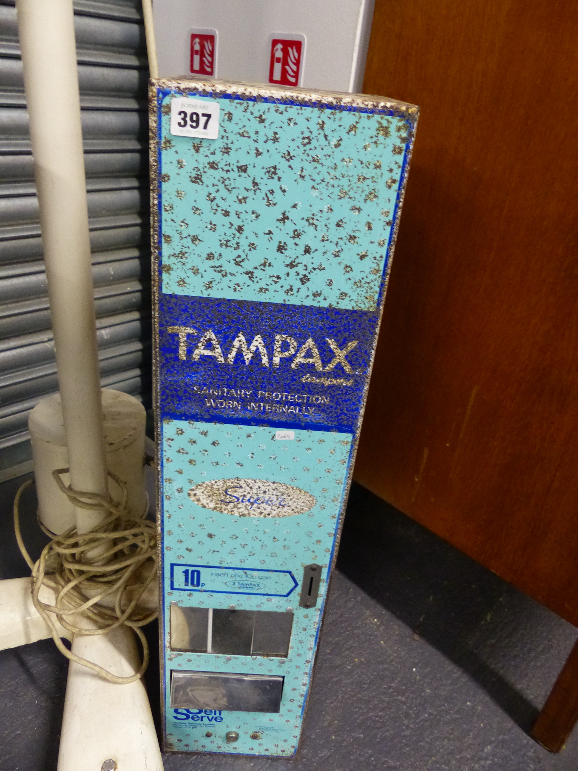 A VINTAGE TAMPAX VENDING MACHINE.