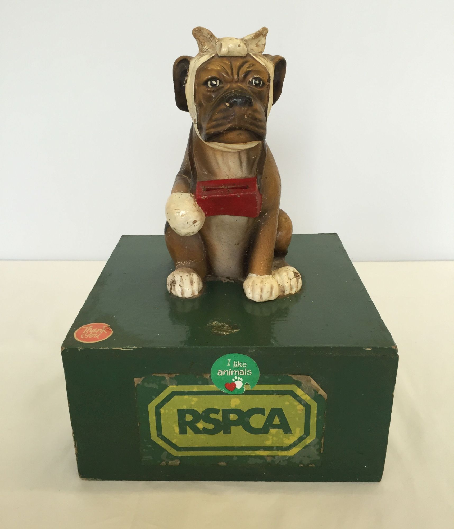 A c1960s RSPCA boxer dog charity collection box.