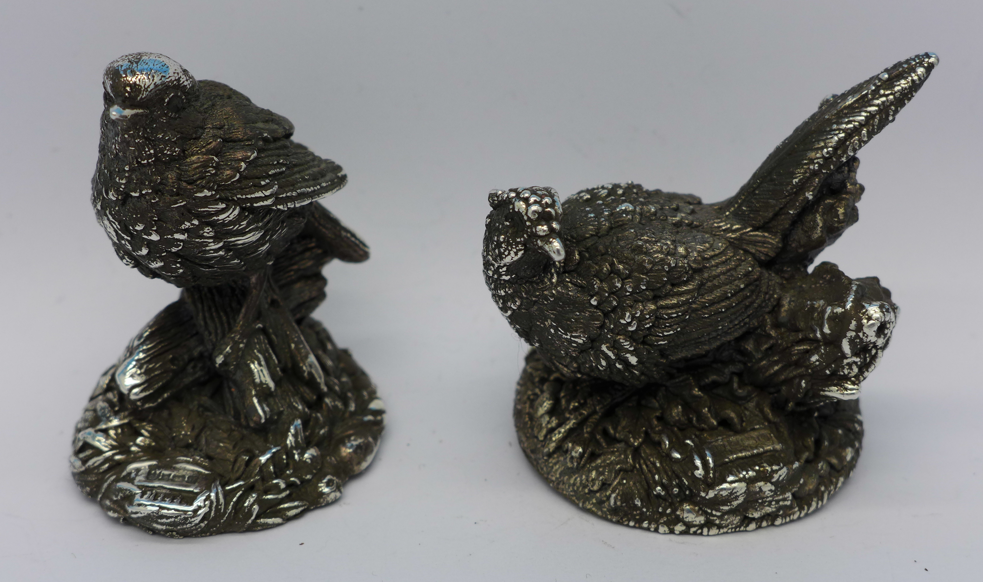 Two hallmarked silver birds, (filled)
