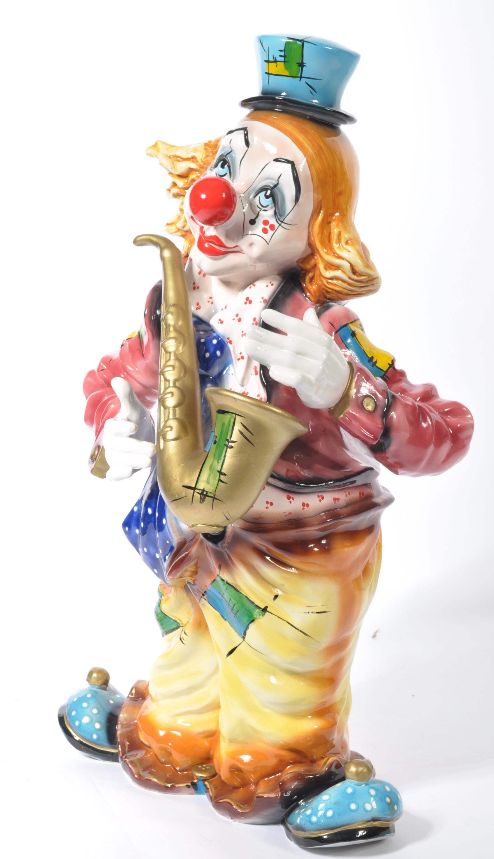 A fantastic 20th century ceramic floor standing clown, finished with an ...