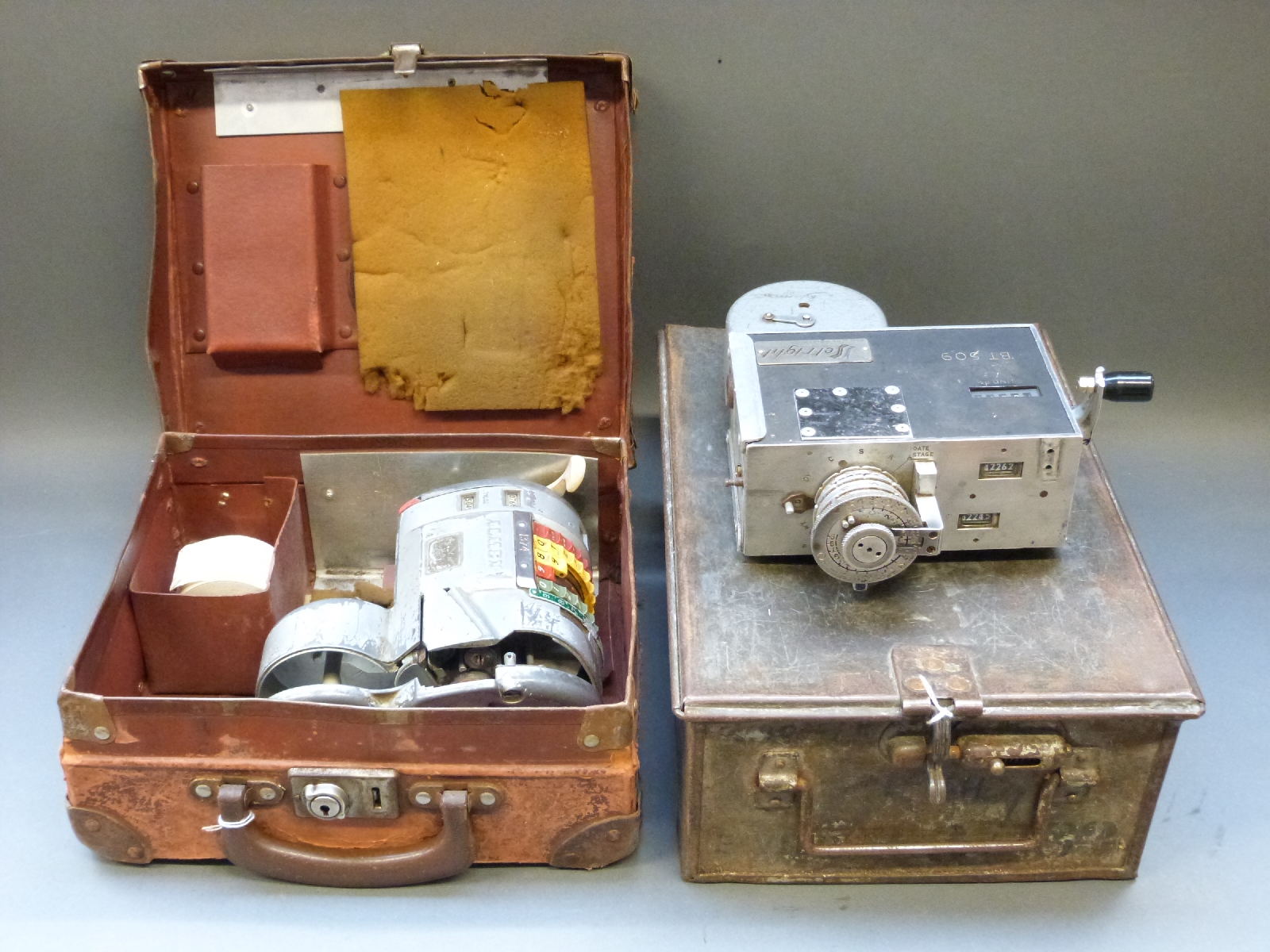 A Setright vintage ticket machine in box and an Almex example in case